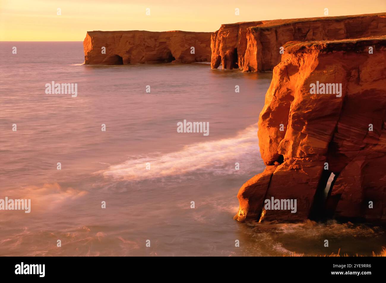 Sandstone cliffs in sunset light on Grindstone Island, Magdalen Islands ...