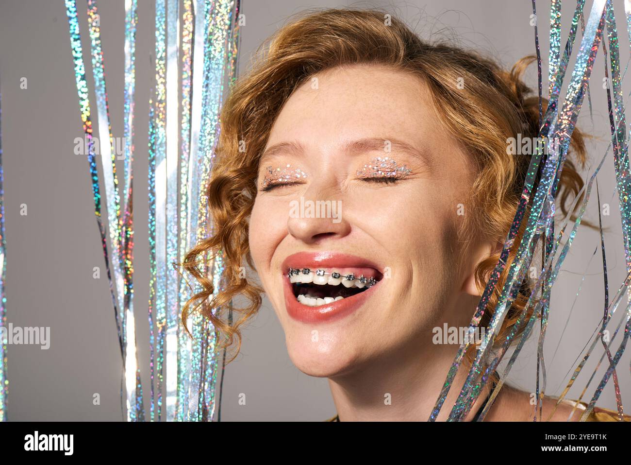 A young woman smiles brightly while posing actively, surrounded by ...