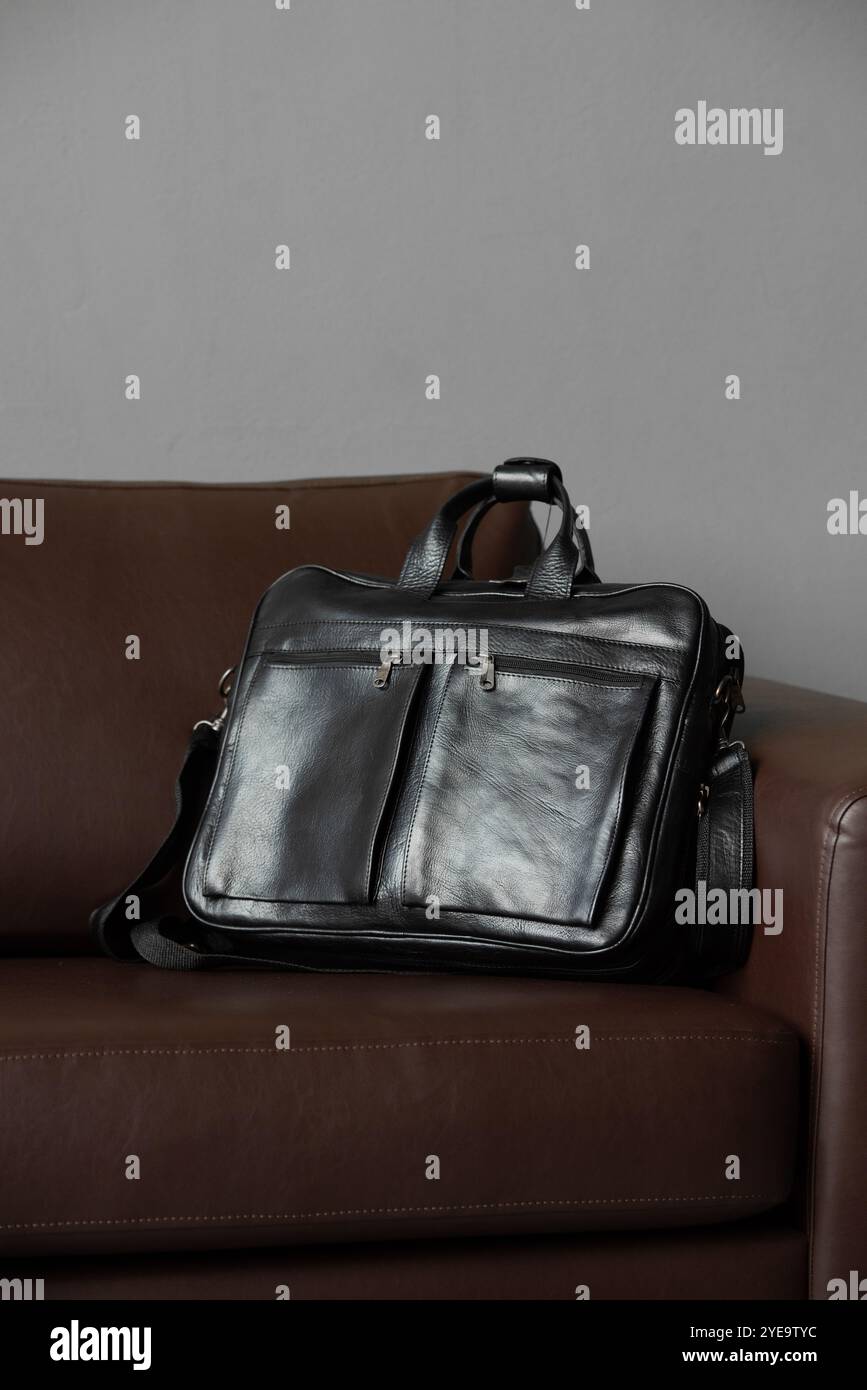 black briefcase on a brown couch Stock Photo - Alamy