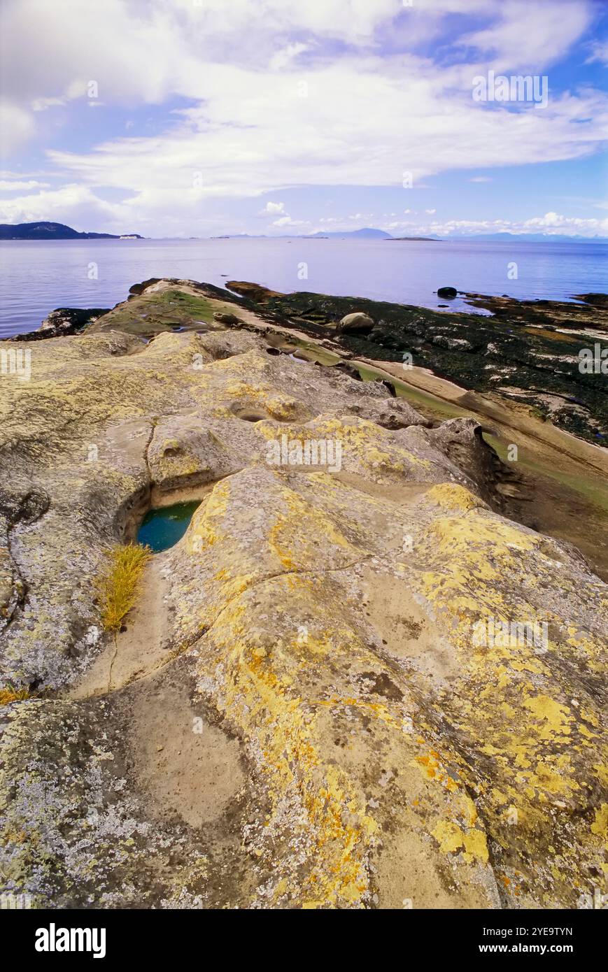Rock and tide pools on the shore of Gabriola Island, with a view of the ...