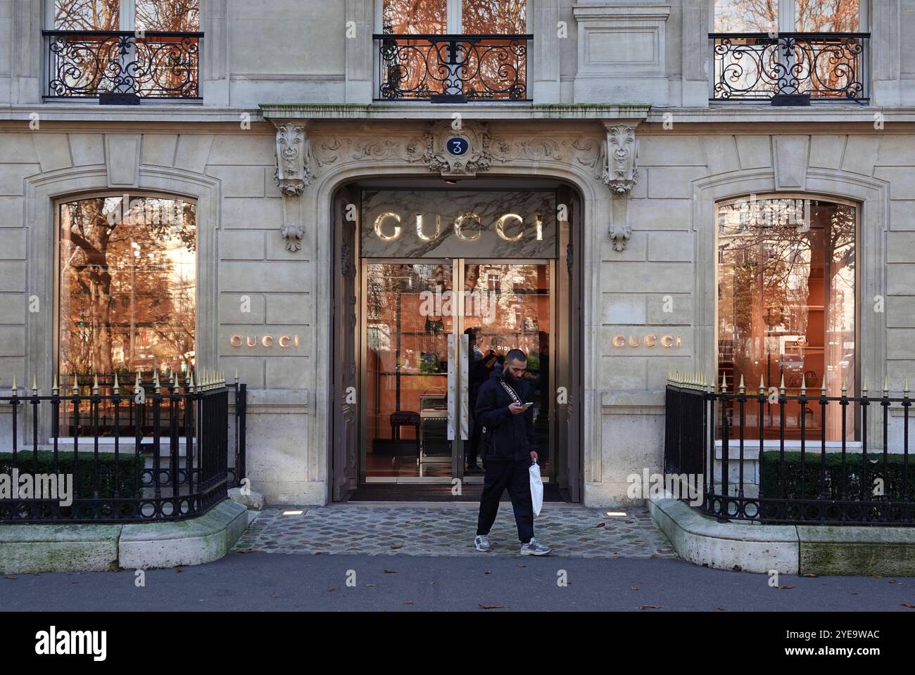 People walking by the Gucci store on the Champs Elysees in Paris Stock ...