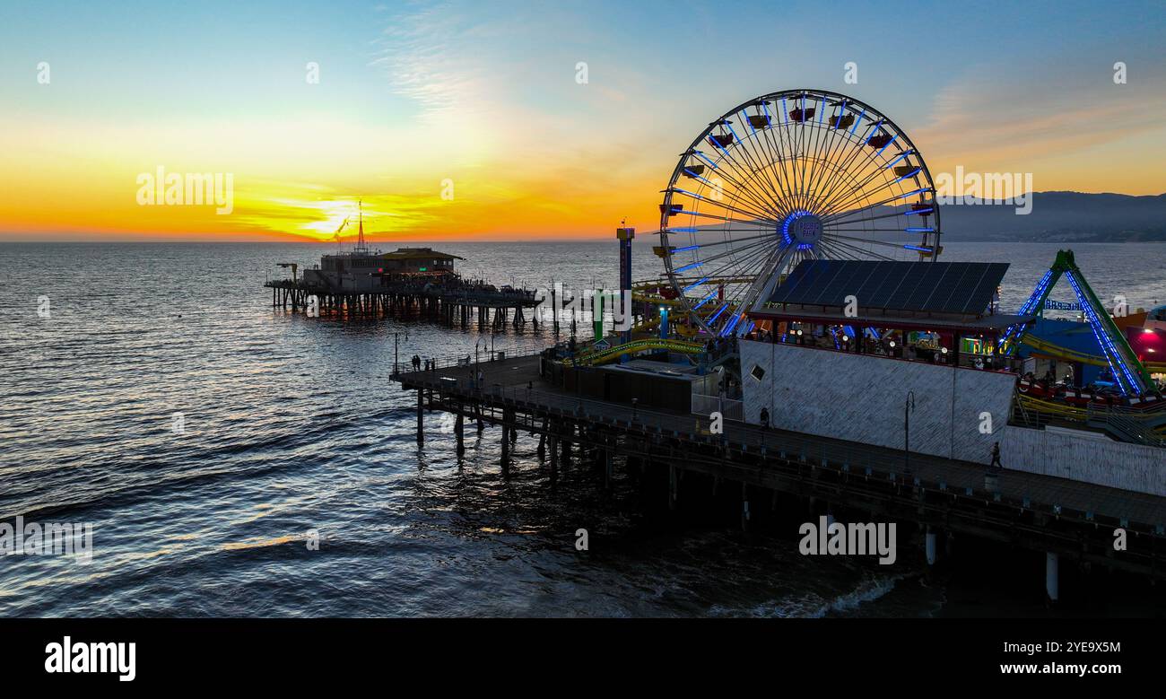 The Santa Monica Beach Pier in California, with Pacific Park at Sunset ...