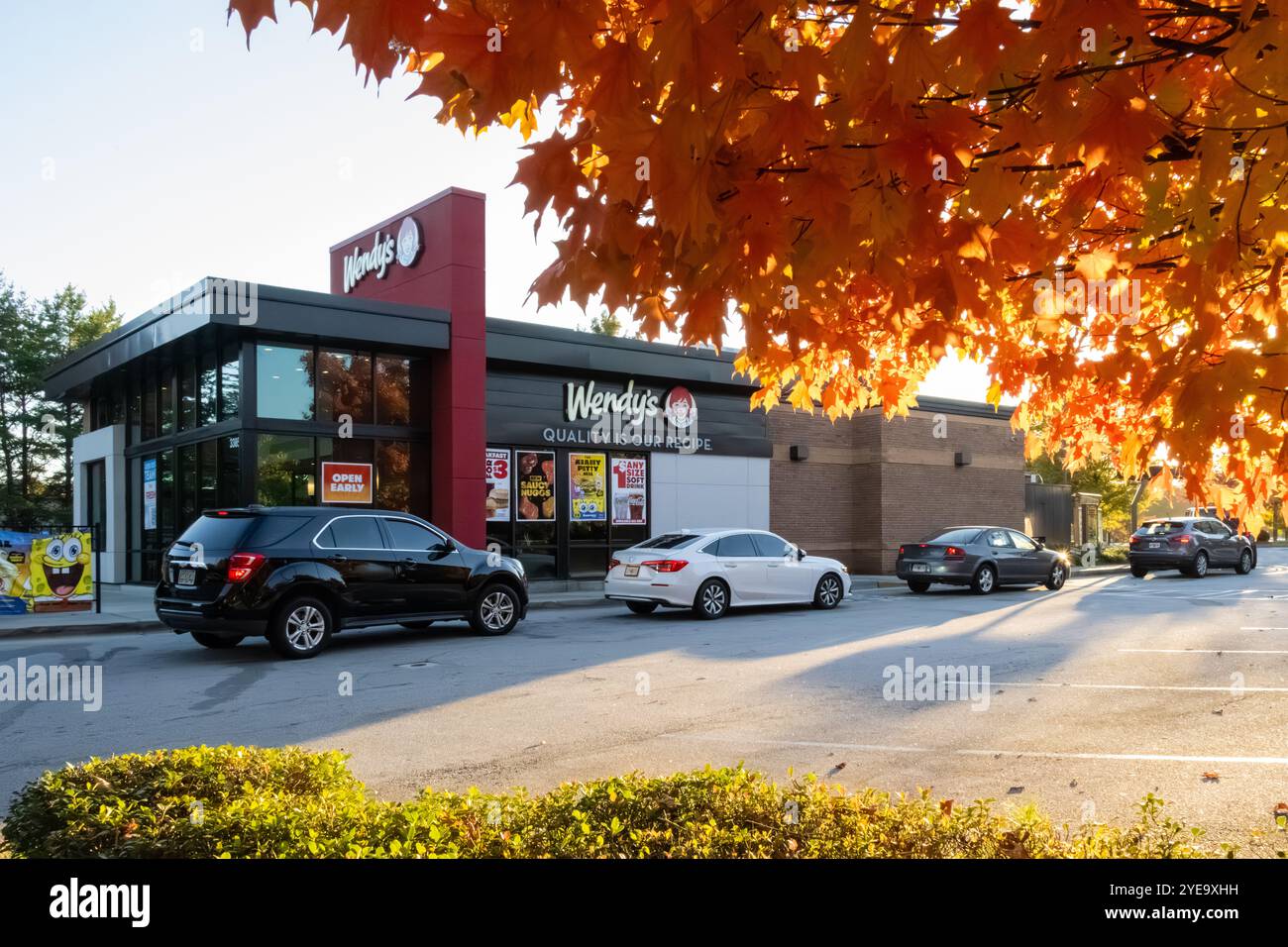 Wendy's fast food restaurant customers in the drive-thru line wrapping the building in ...