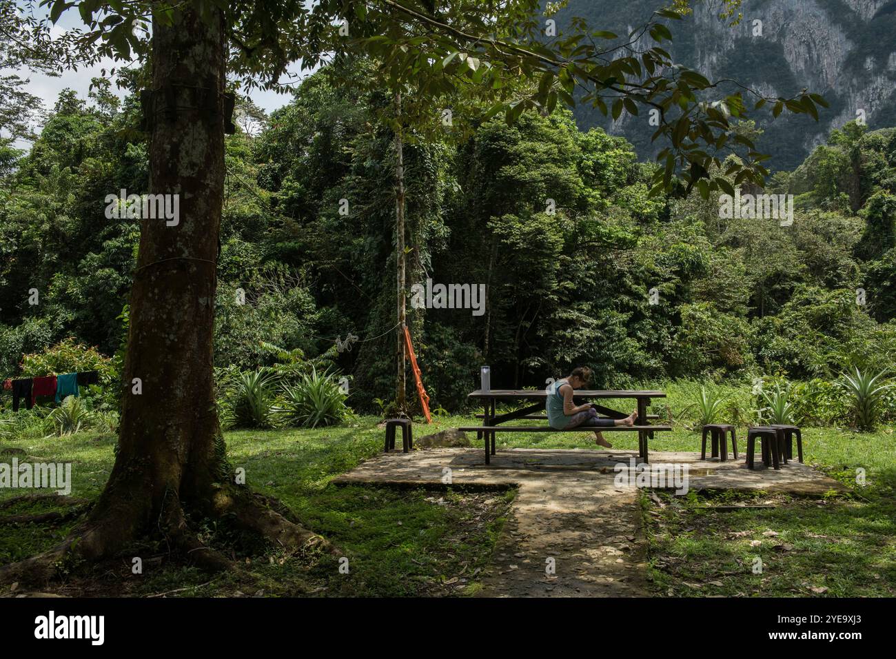 Female caver/scientist enjoys leisure time using her smart phone at a ...