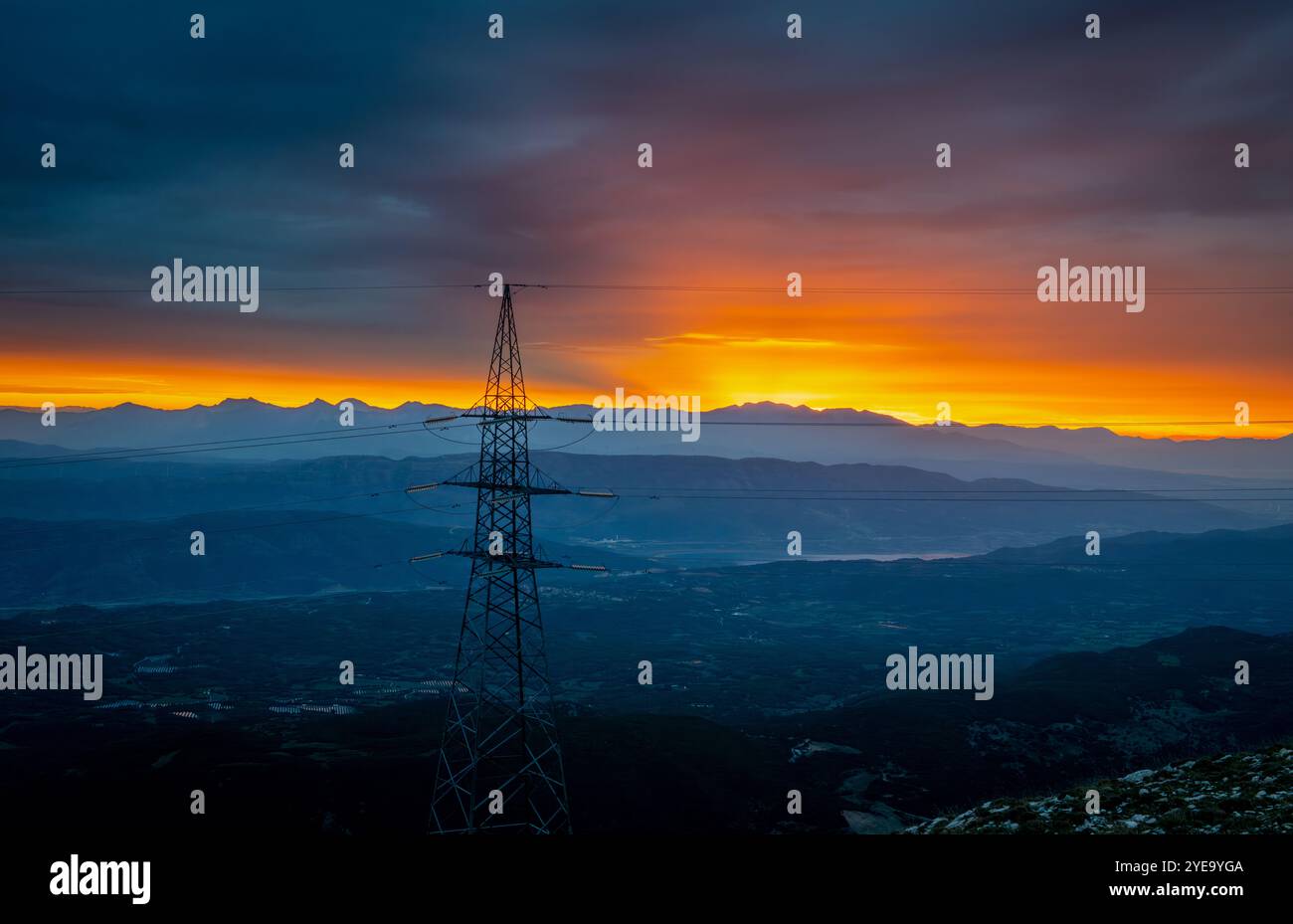 A dramatic mountain top view of the first ray of sunlight on a day with ...