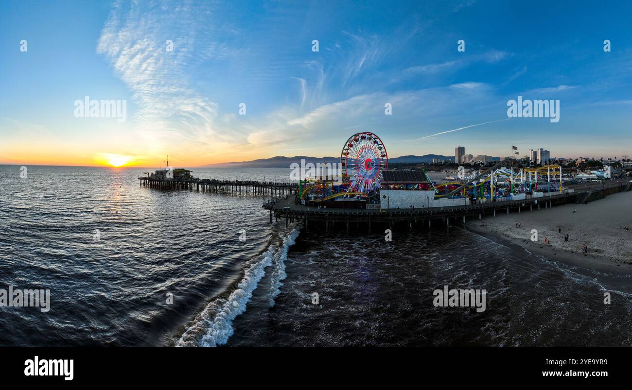 The Santa Monica Beach Pier in California, with Pacific Park at Sunset ...