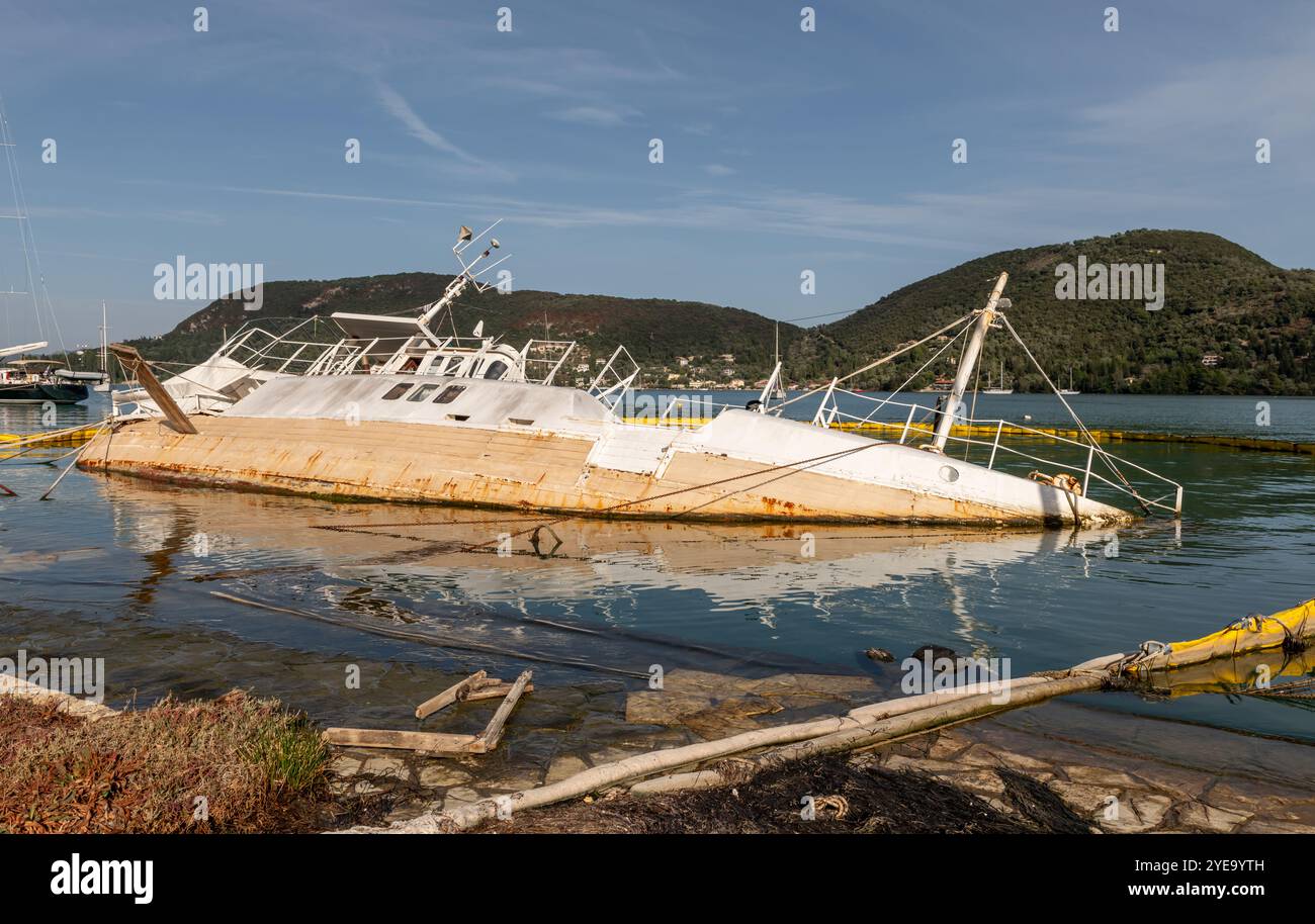 A half submerged sunken boat in shallow water Stock Photo - Alamy