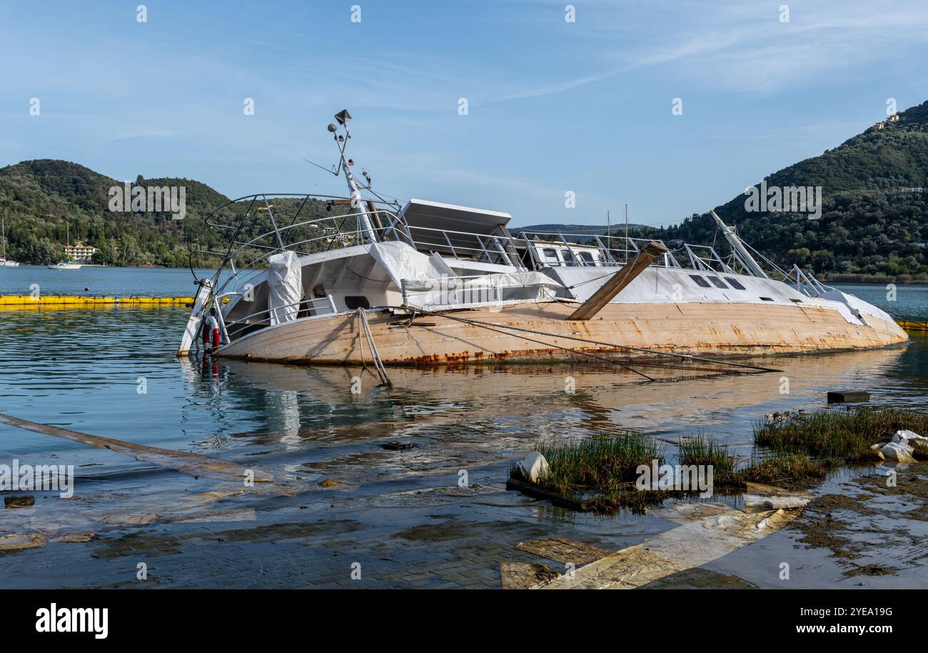 A half submerged sunken boat in shallow water Stock Photo - Alamy