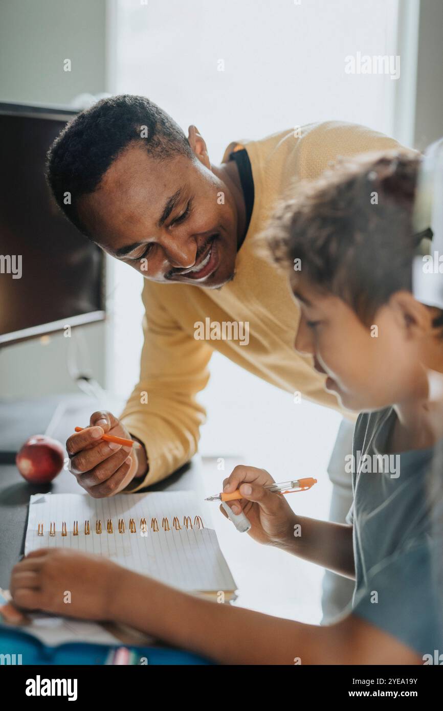 African american family doing homework hi-res stock photography and images - Alamy