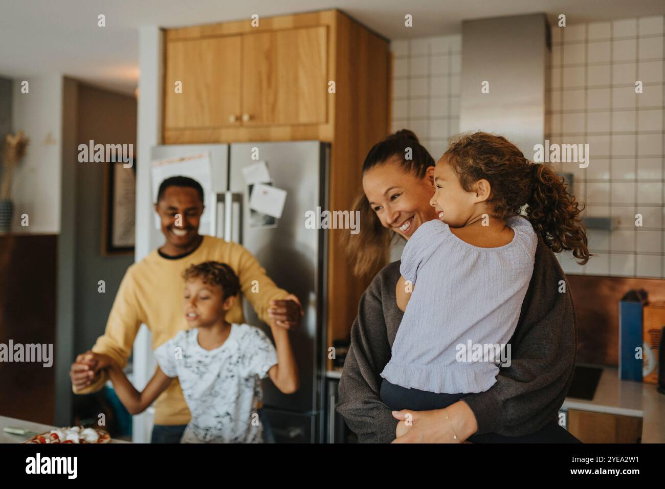 Happy multiracial family enjoying in kitchen at home Stock Photo - Alamy