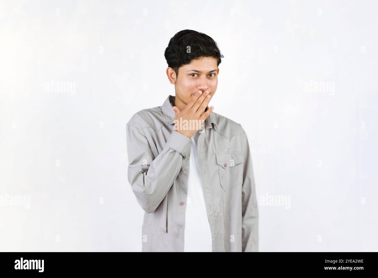 Young Teenager in shirt and vest gives expression of happiness and ...