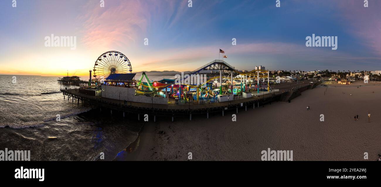 The Santa Monica Beach Pier in California, with Pacific Park at Sunset ...