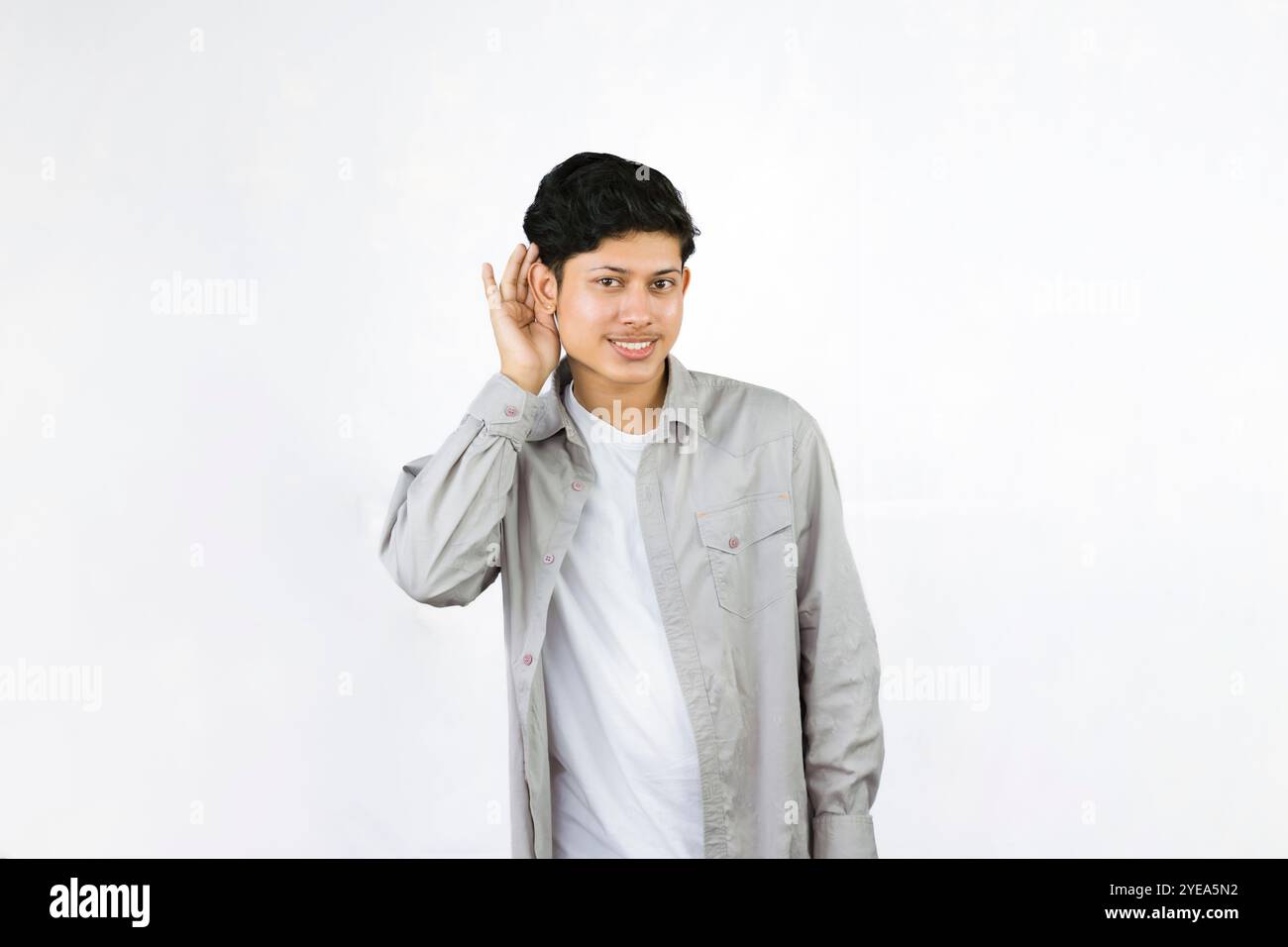 Young Teenager in shirt and vest gives expression of happiness and ...