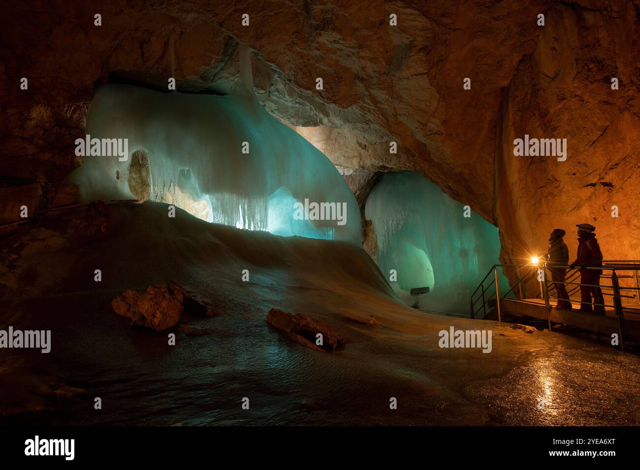 People standing inside the illuminated ice cave of the Eisriesenwelt ...