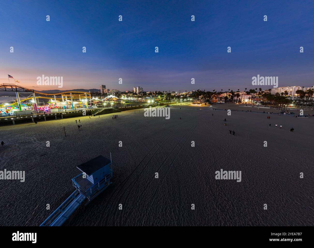 The Santa Monica Beach Pier in California, with Pacific Park at Sunset ...