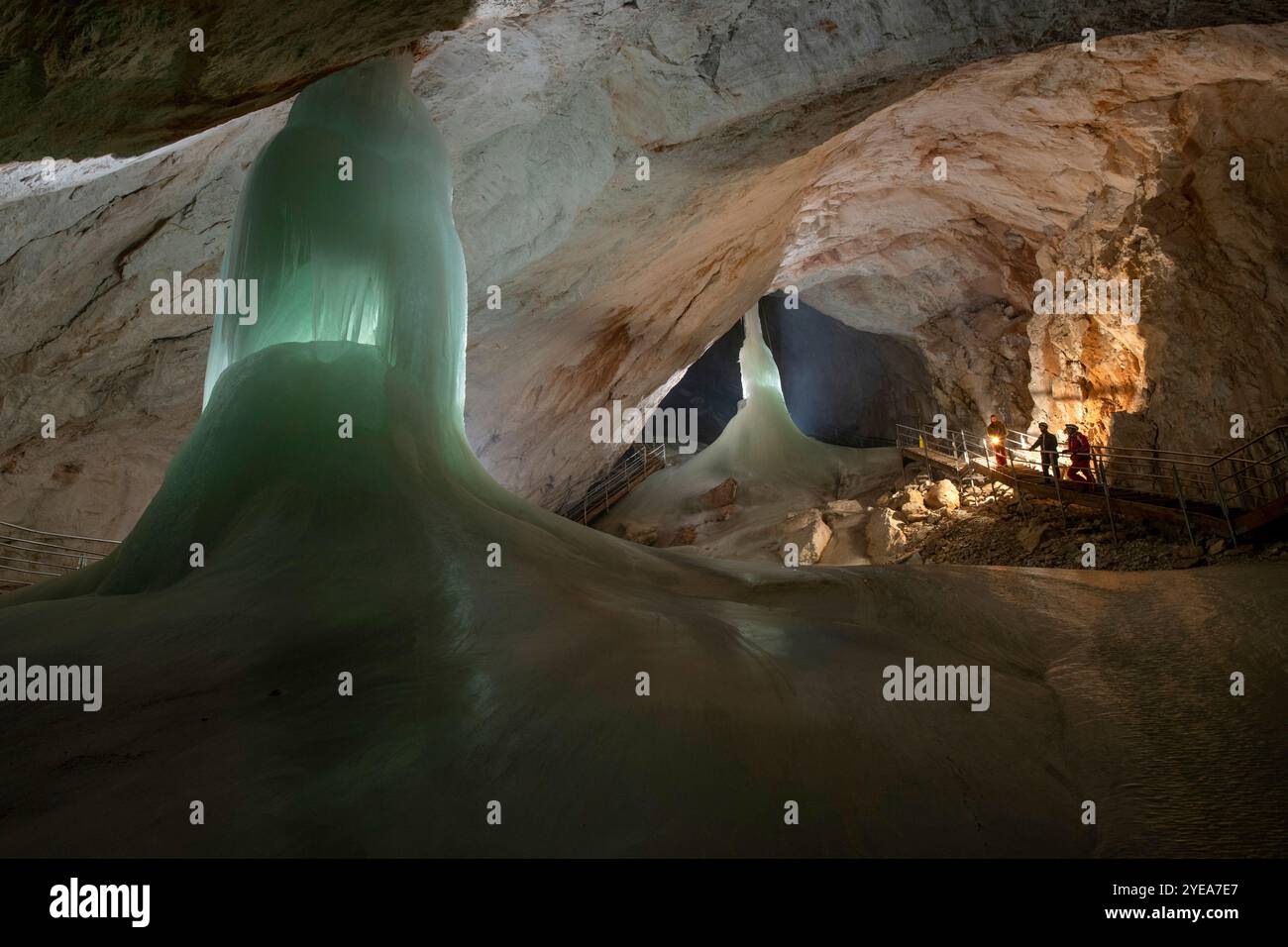 People standing inside the illuminated ice cave of the Eisriesenwelt ...
