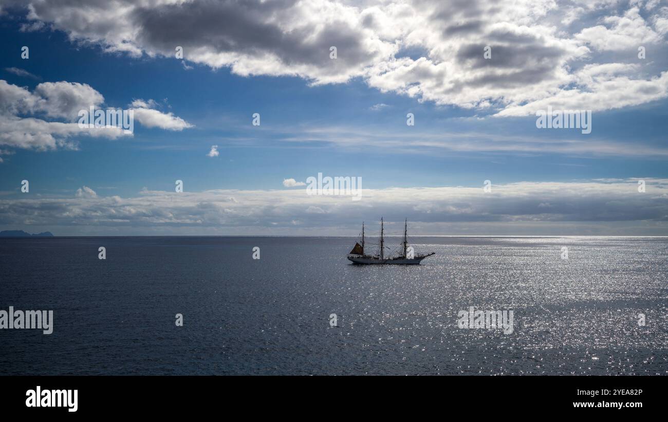 Three mast ship sailing in the North Atlantic under a blue sky with ...
