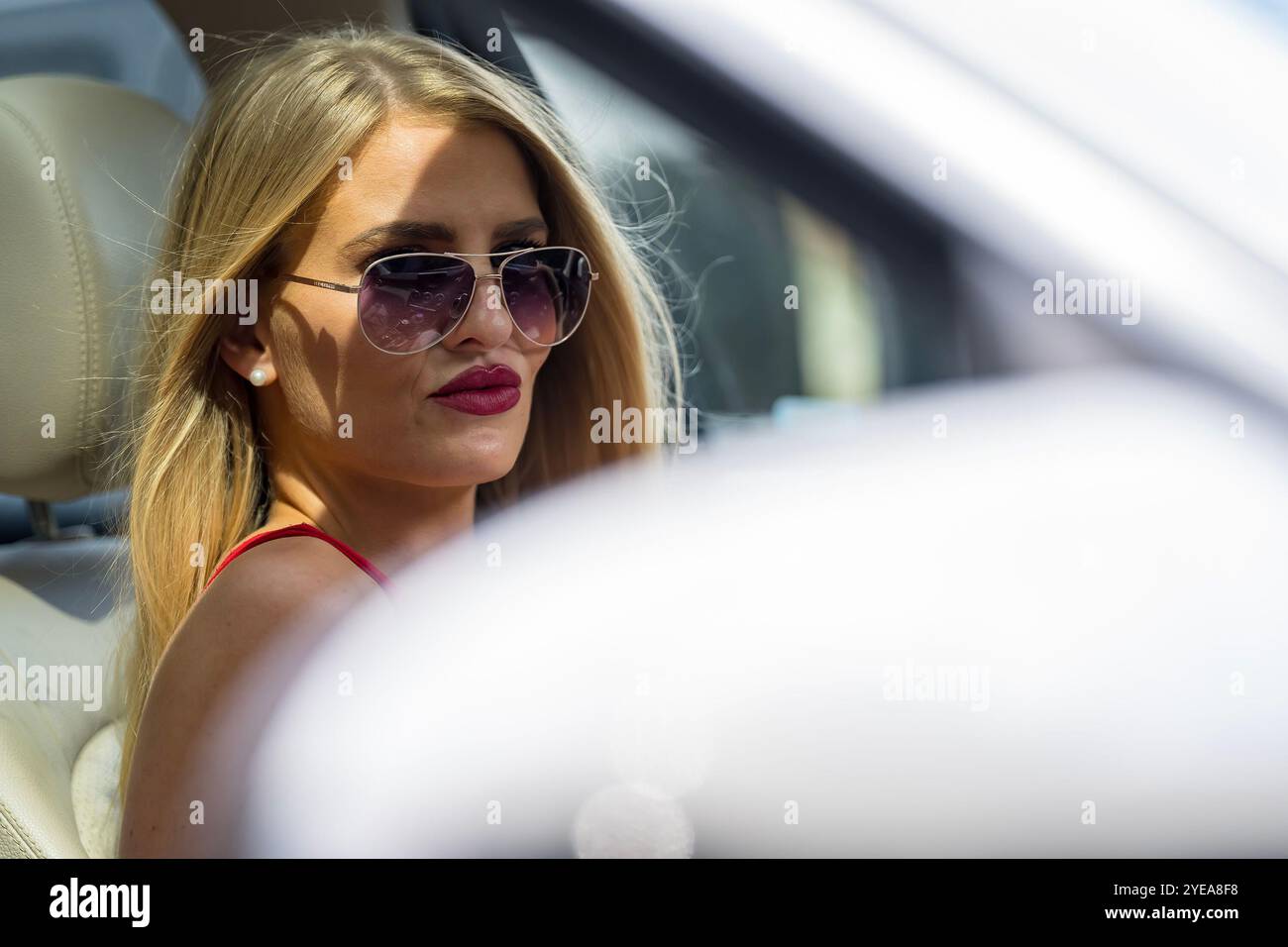 A gorgeous blonde woman playfully flirts with her lover inside her ...