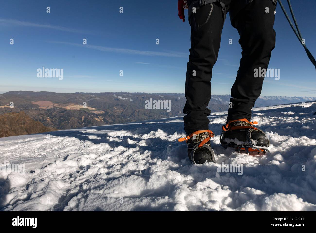 Top view of man standing with snow climbing crampons, safety equipment ...