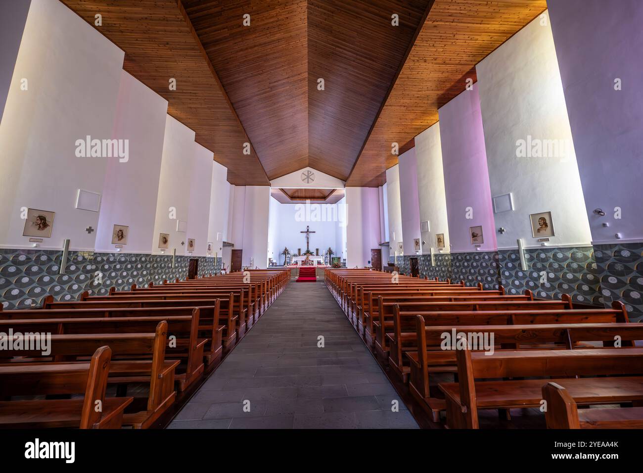 Altar at the end of a center aisle in a church sanctuary with wooden ...