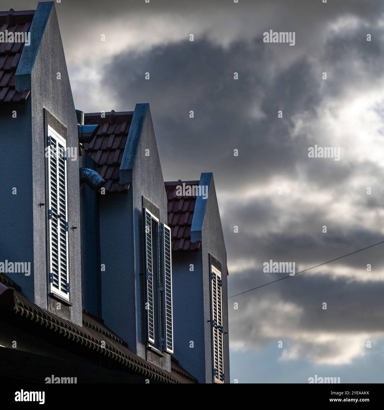 Architectural detail of a residential building with three peaked ...