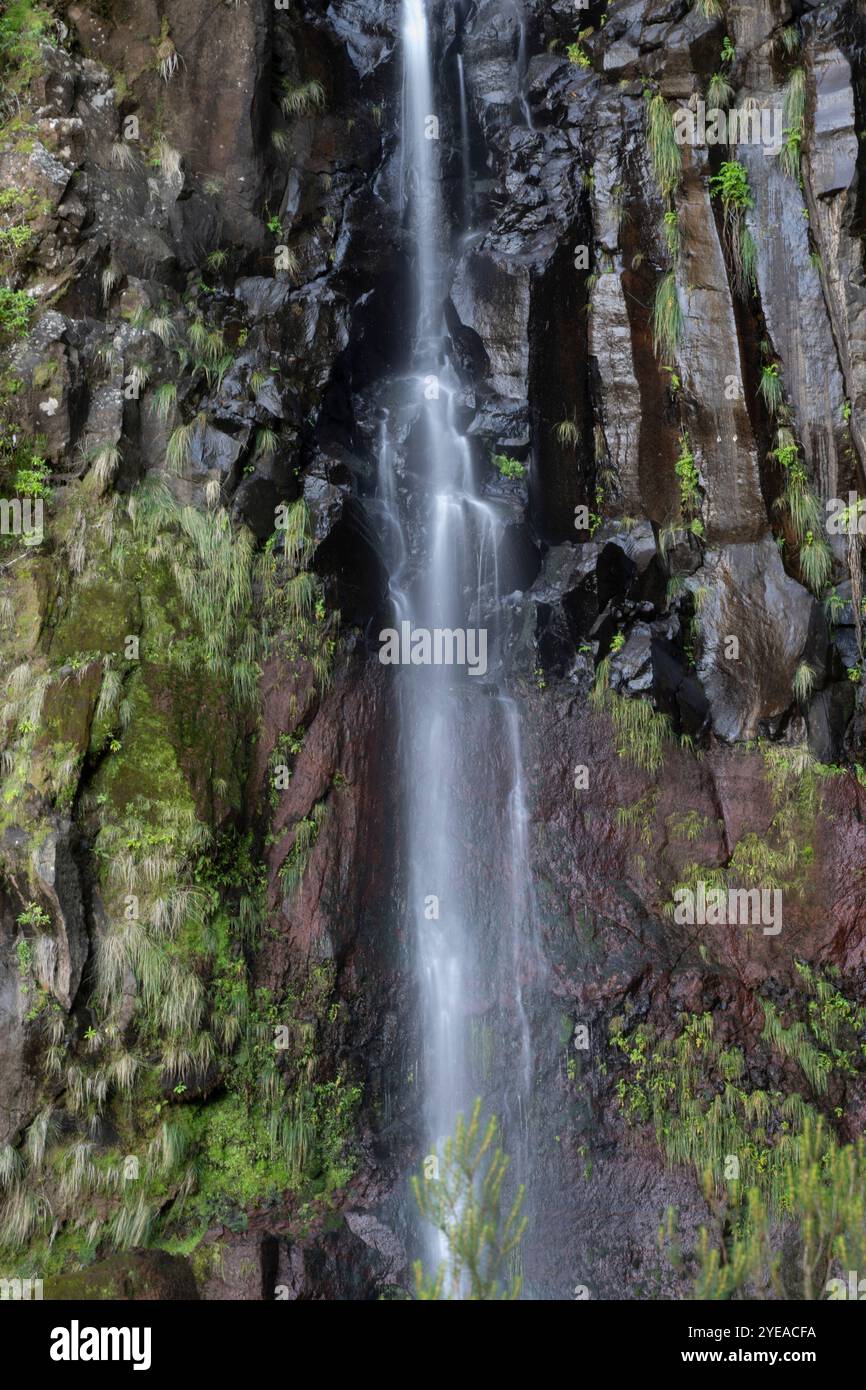 Beautiful waterfall on a rugged mossy cliff, Risco Waterfall on the ...