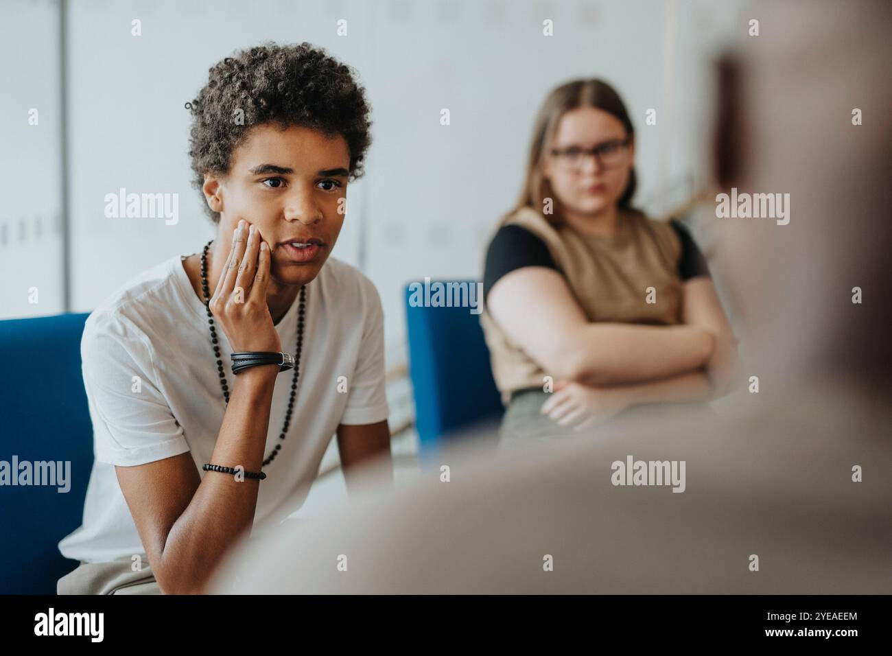 Teenage boy discussing with male counselor at high school Stock Photo ...