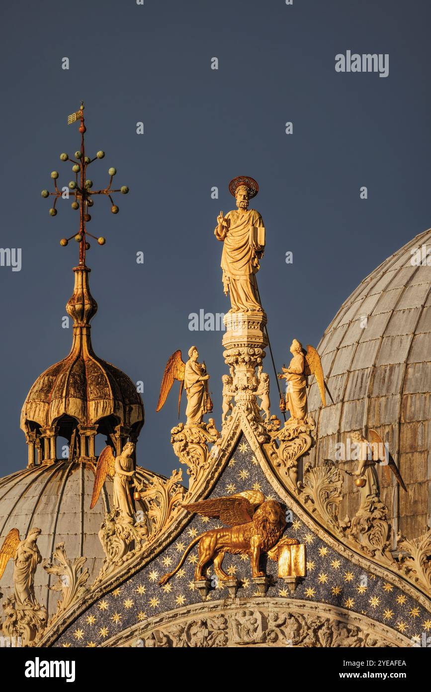 Ornate rooftop of Saint Mark's Basilica with sunlit statues of St Mark ...