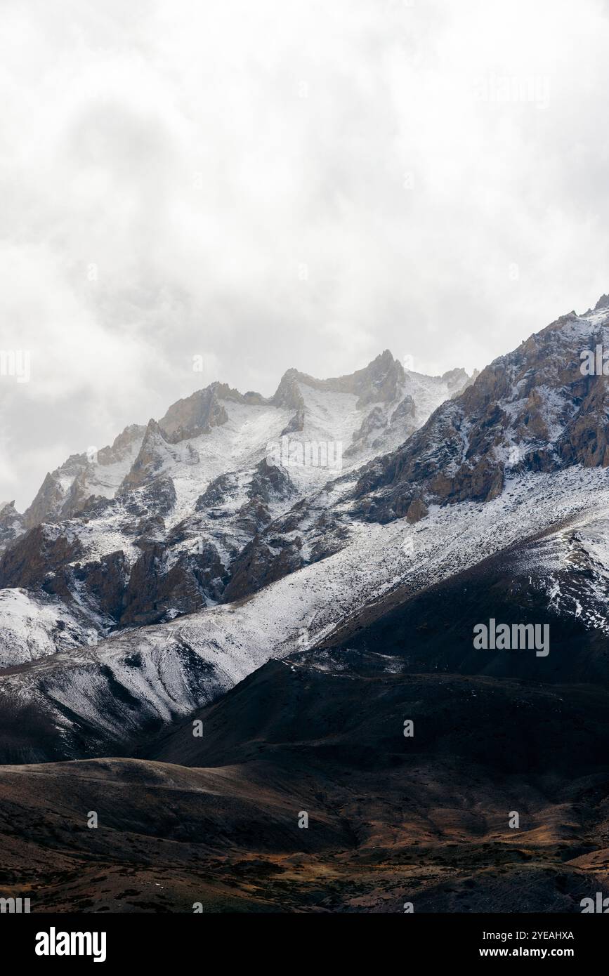 Beautiful rugged Zanskar mountains covered in snow under an overcast ...