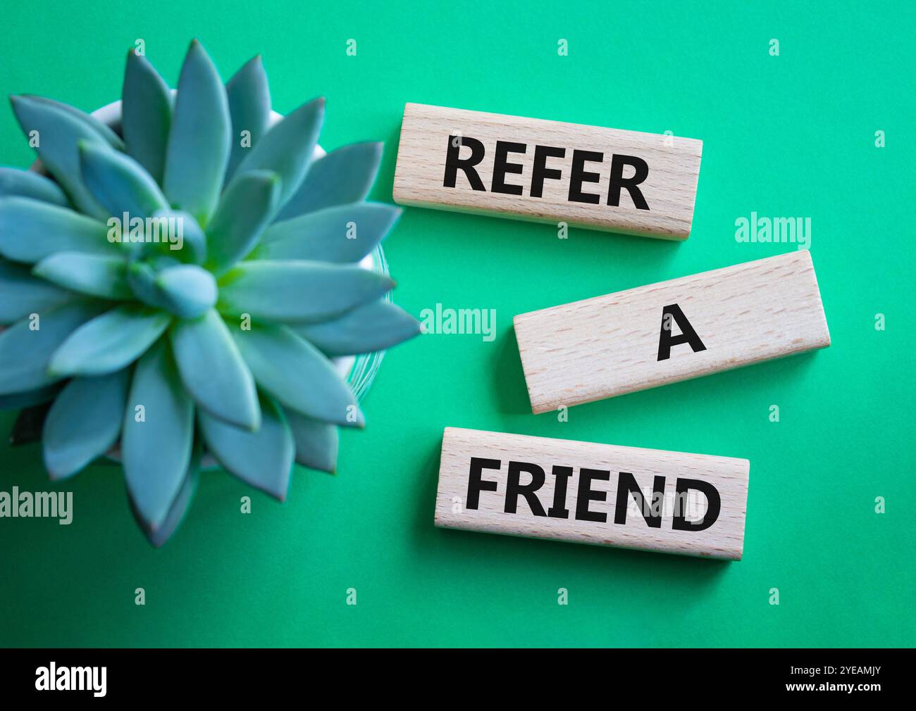 Refer a Friend symbol. Concept words Refer a Friend on wooden blocks ...