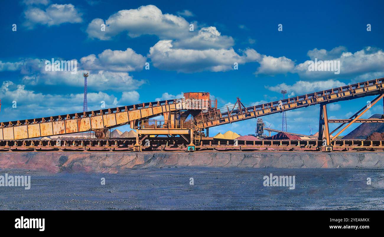 Loading iron ore conveyor machine on blue sky background in steel ...