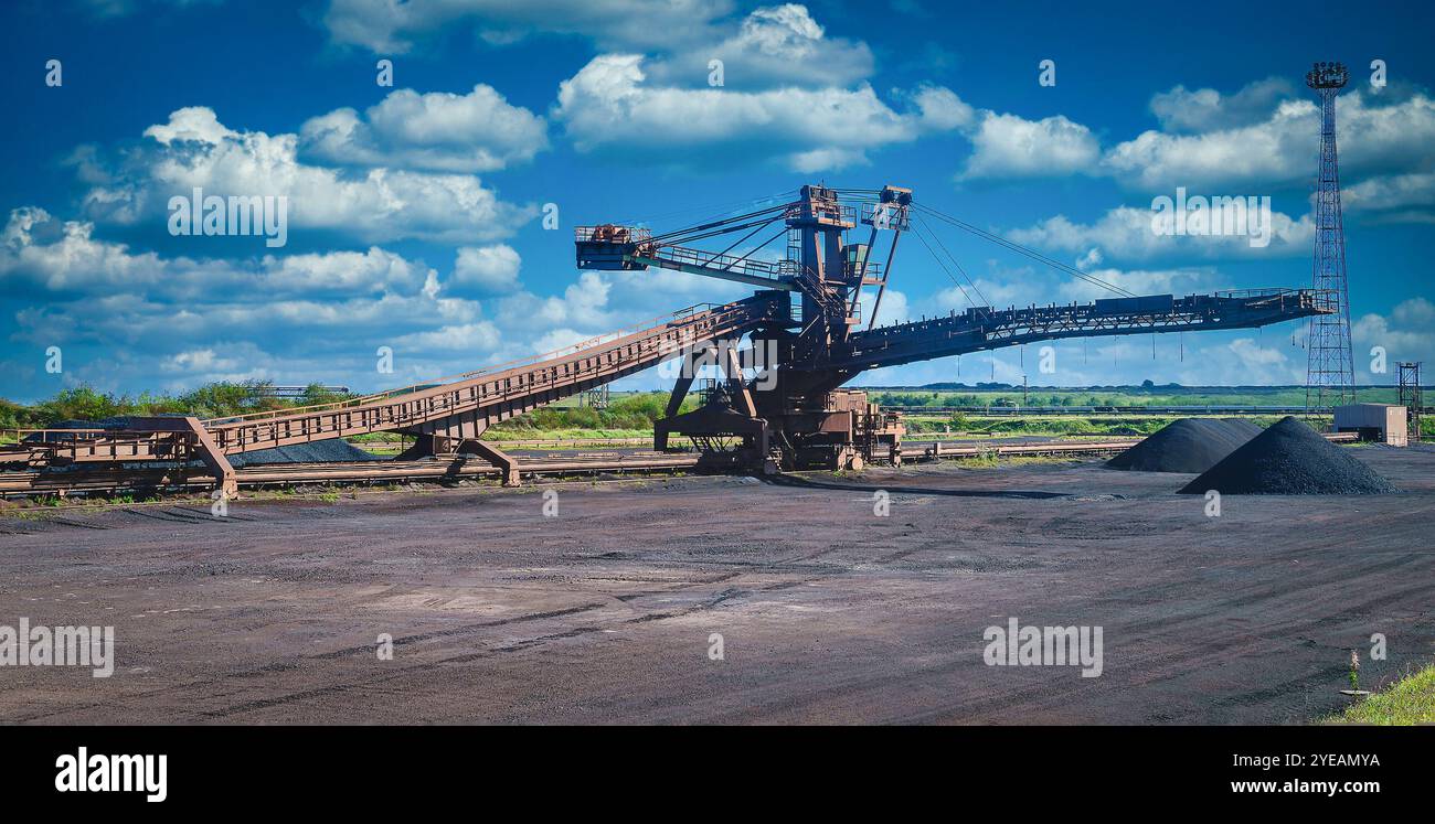 Loading iron ore conveyor machine on blue sky background in steel ...