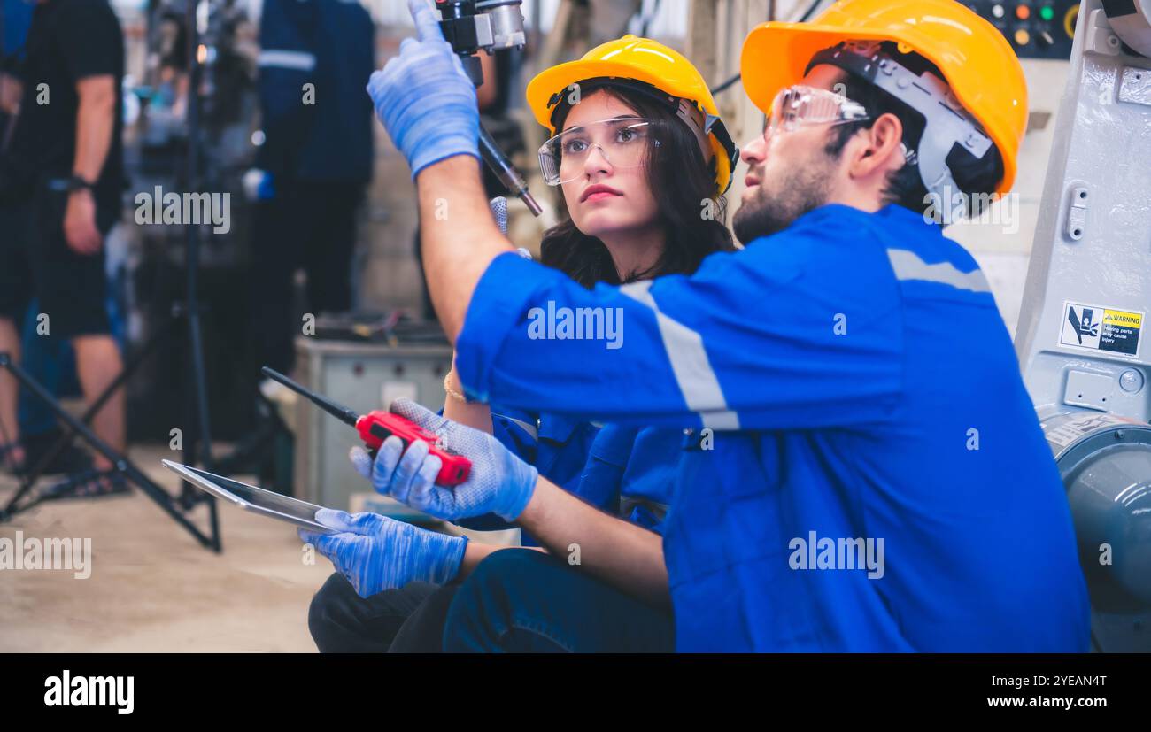 Engineers team mechanic using computer controller Robotic arm for ...