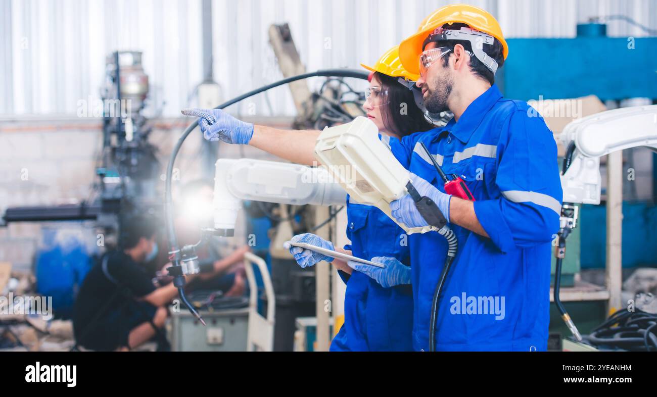 Engineers team mechanic using computer controller Robotic arm for ...