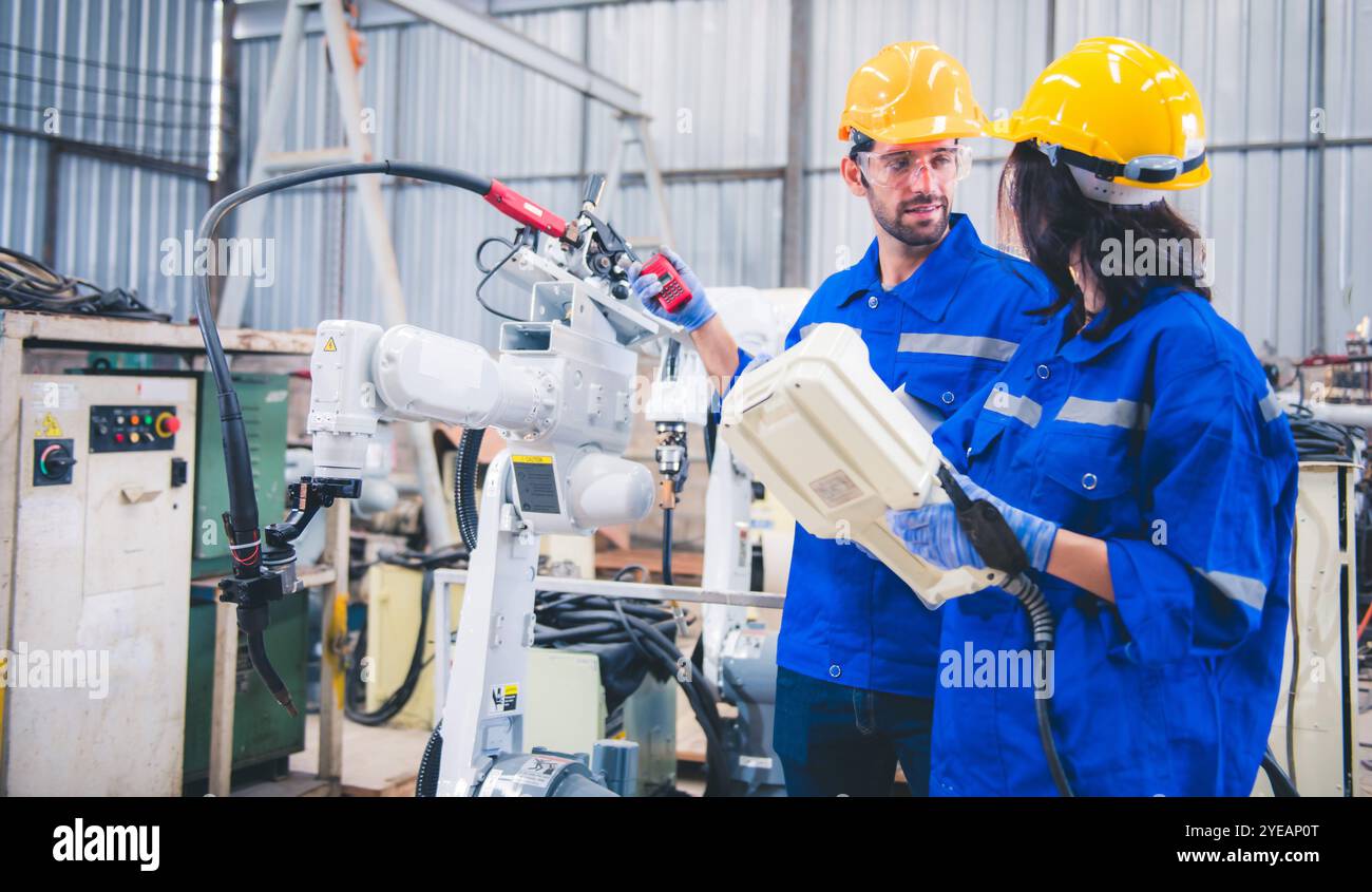 Engineers team mechanic using computer controller Robotic arm for ...
