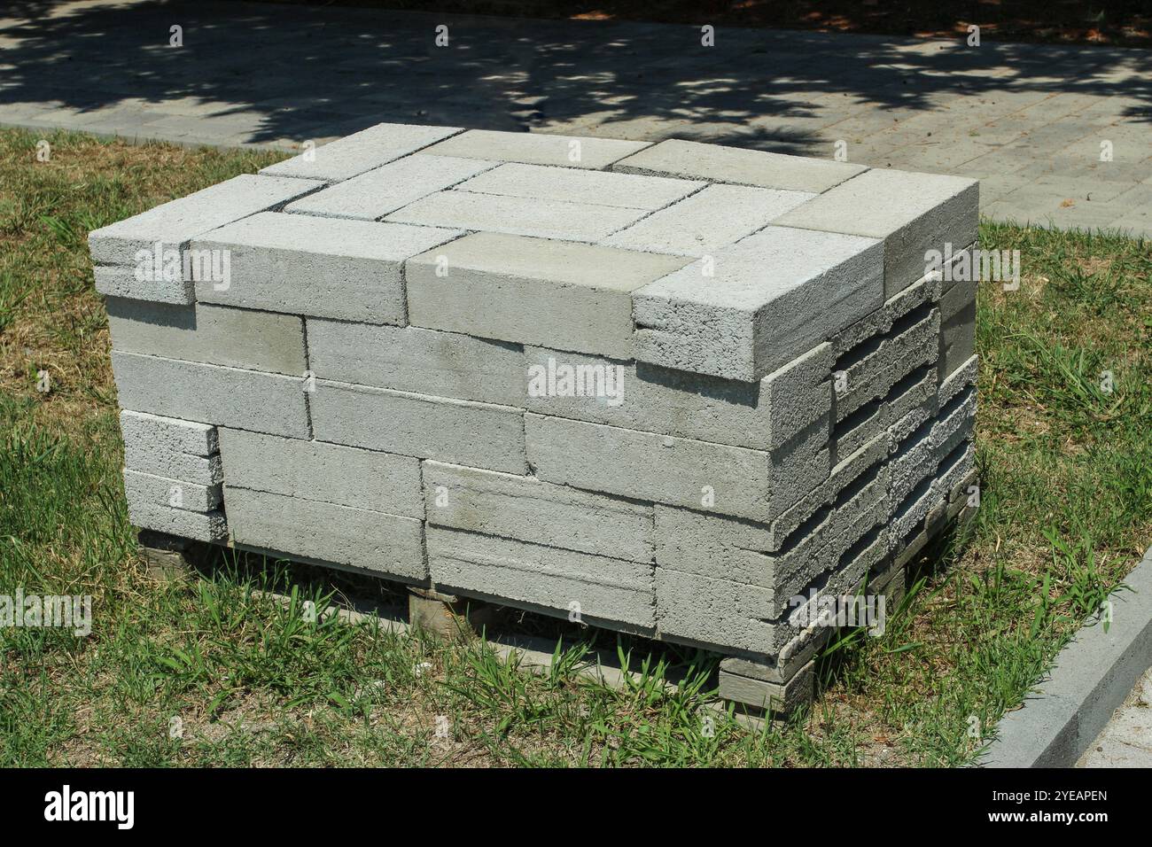 Expanded clay concrete building blocks are stacked on a standard wooden ...