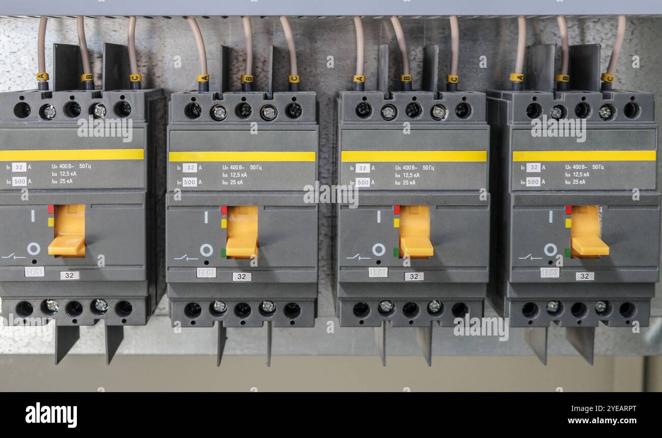 Three-phase circuit breakers in an electrical panel Stock Photo - Alamy