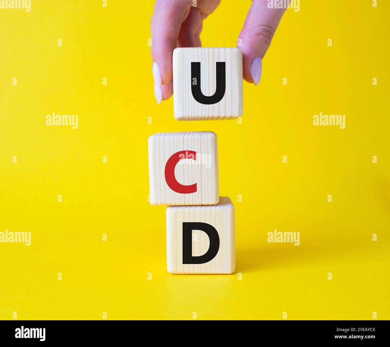UCD - User Centered Design. Wooden cubes with word UCD. Businessman ...