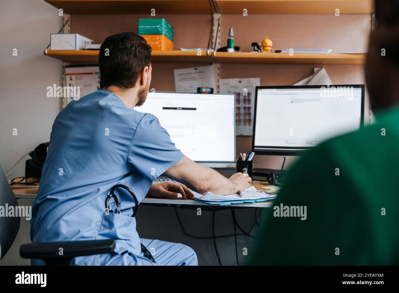 Nurse checking patient in computer hi-res stock photography and images ...