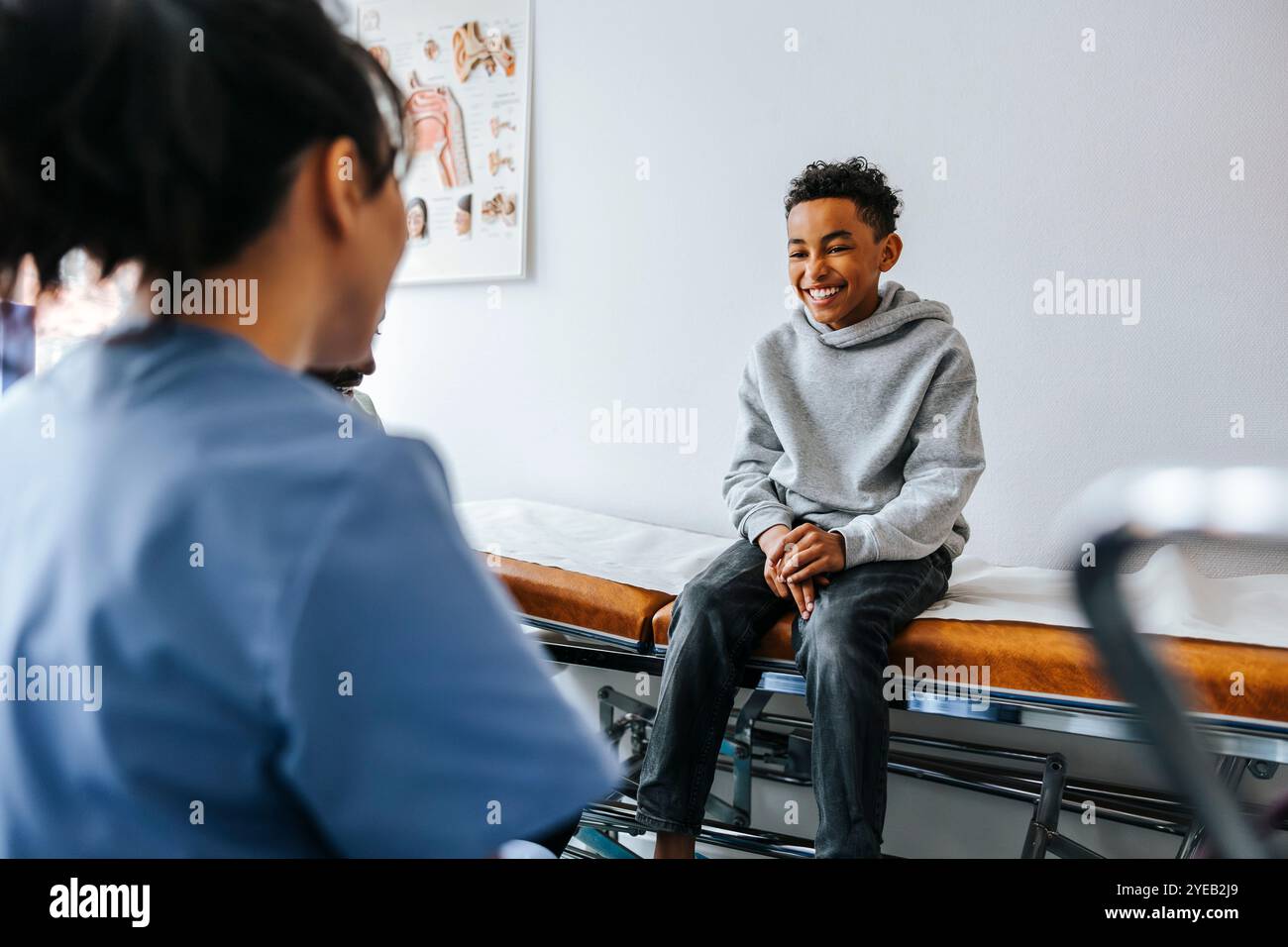 Boy sitting on examination table hi-res stock photography and images ...
