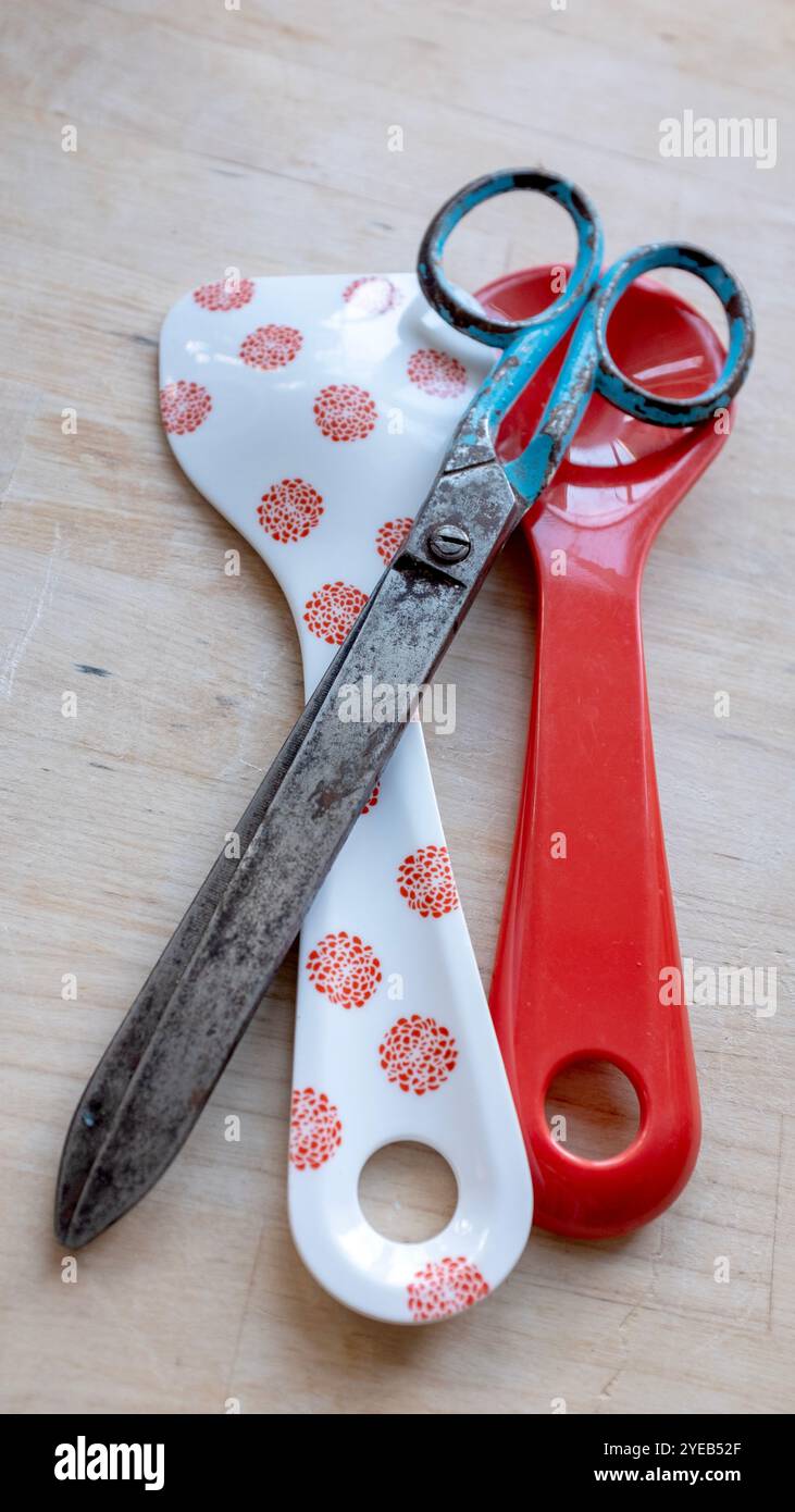A pair of old rusty, metal, vintage scissors with a new plastic pair of ...