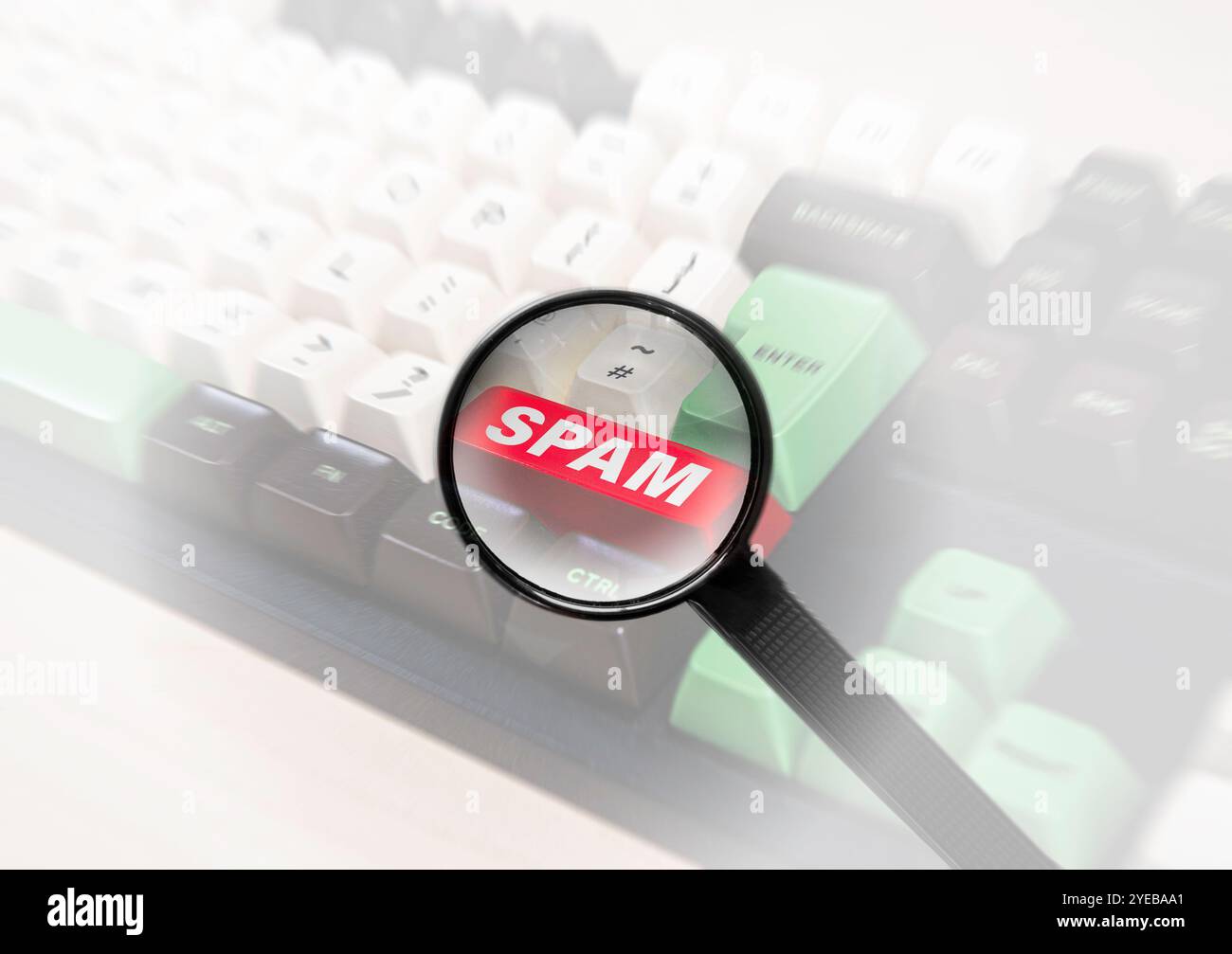 Magnifying glass focusing on the word SPAM in red as a keyboard key ...