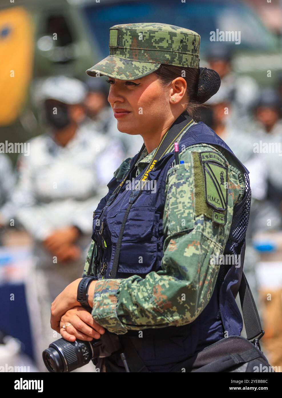 A female soldier of the Mexican army photographs at a public event of ...