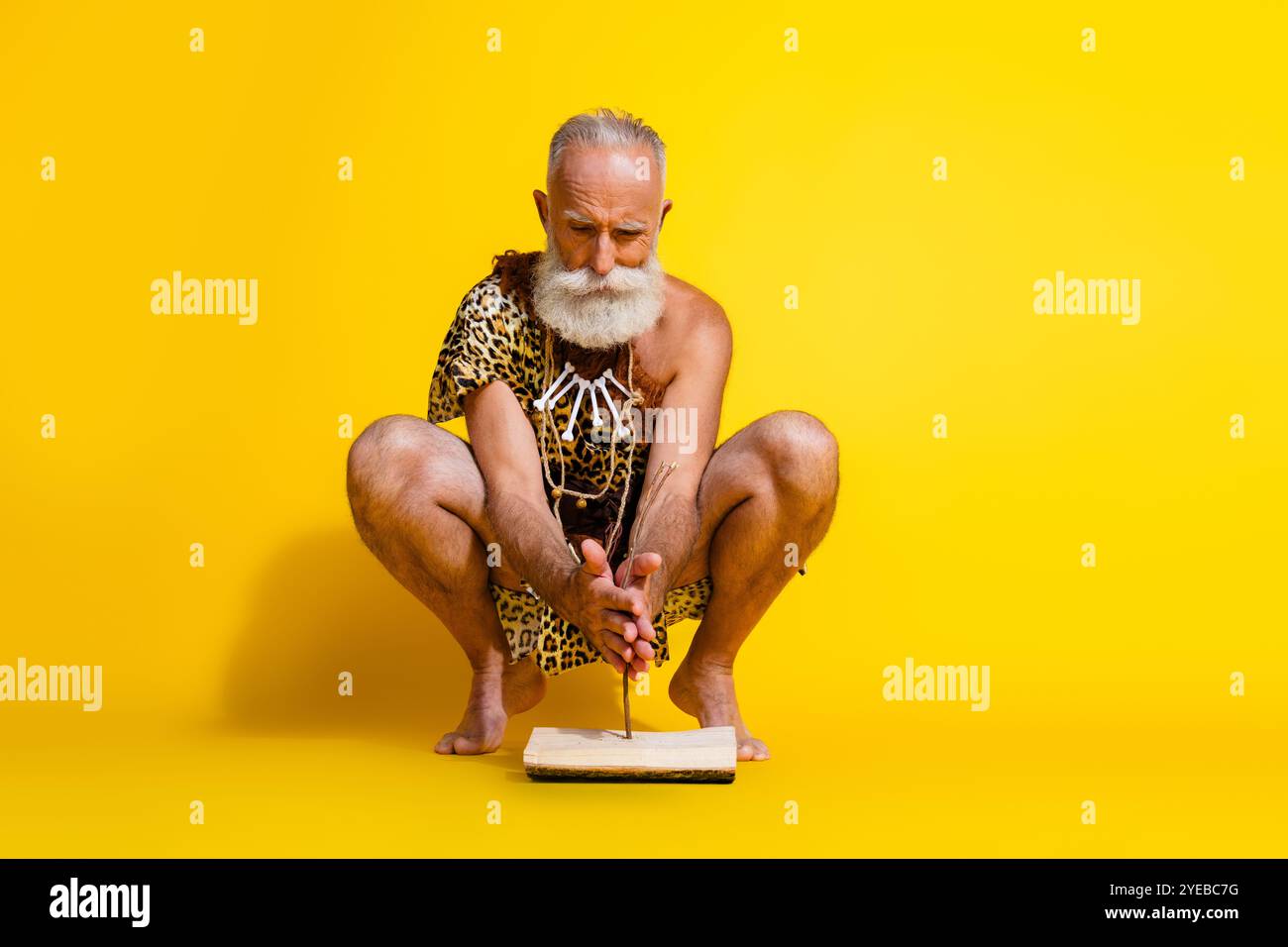 Full length portrait of primeval caveman wood stick make fire leopard ...