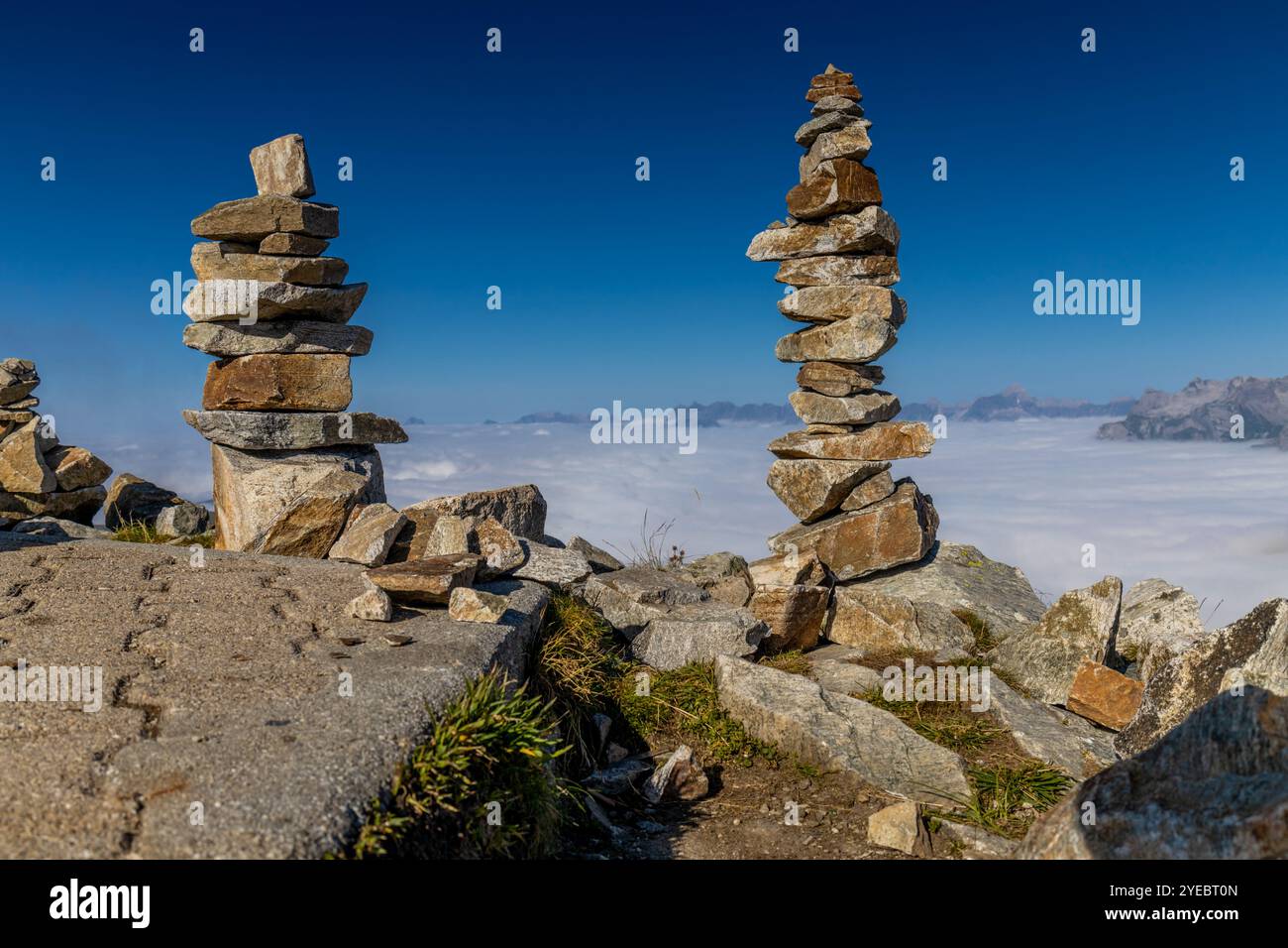 Stone pyramid in the mountains on the summit and ountain pass marking ...