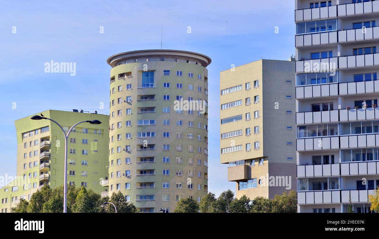 Modern high-rise apartment building in white, stand tall against a blue ...