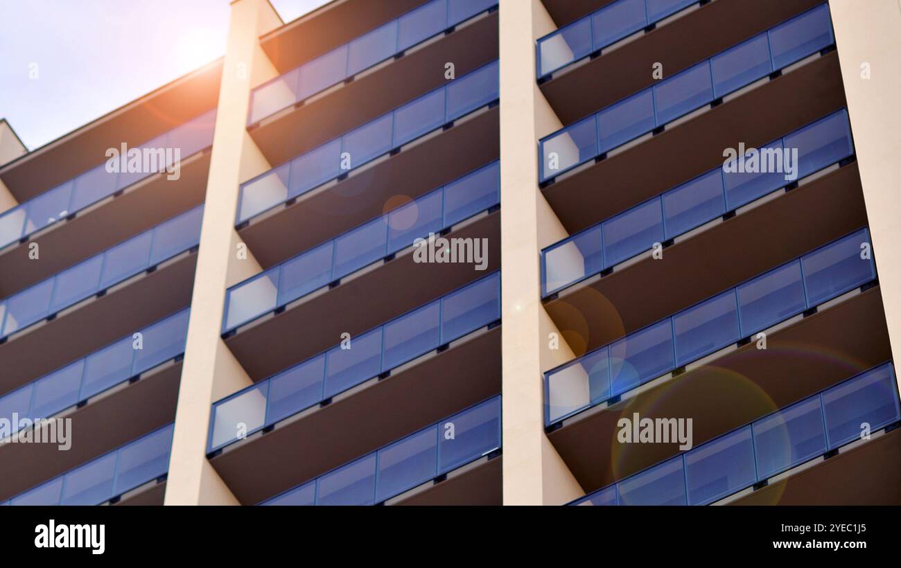 Modern high-rise apartment building in white, stand tall against a blue ...
