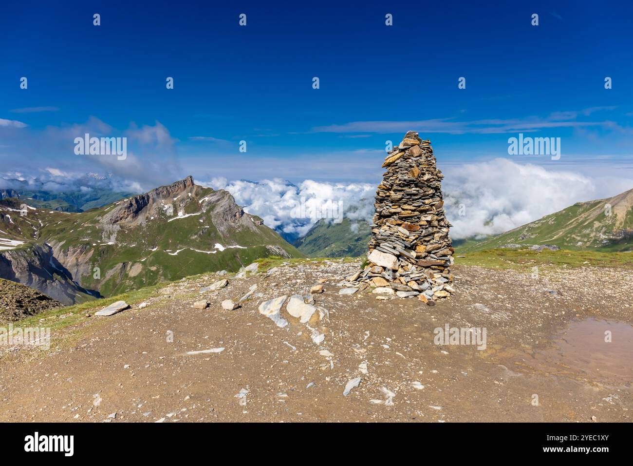 Stone pyramid in the mountains on the summit and ountain pass marking ...
