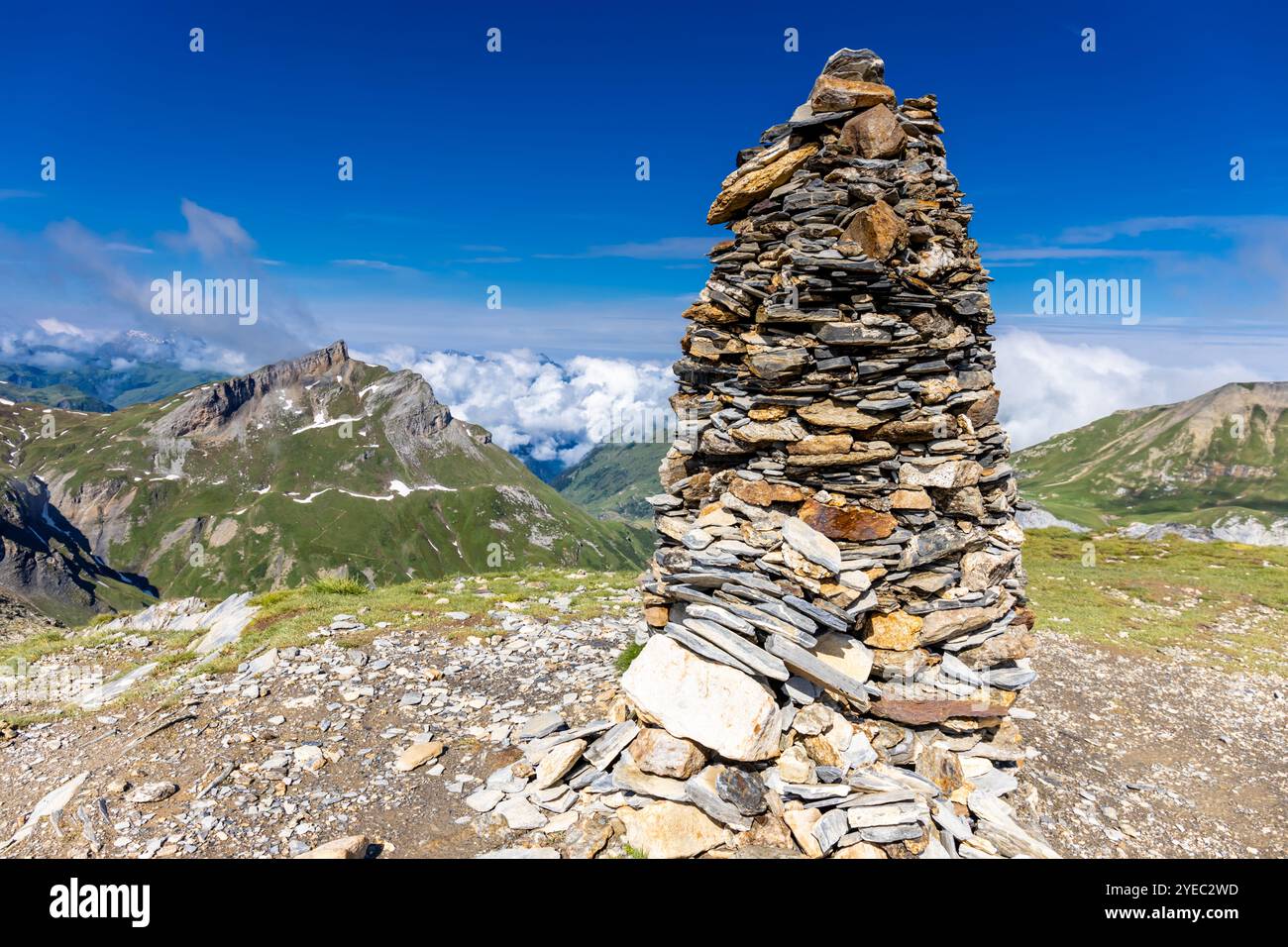Stone pyramid in the mountains on the summit and ountain pass marking ...