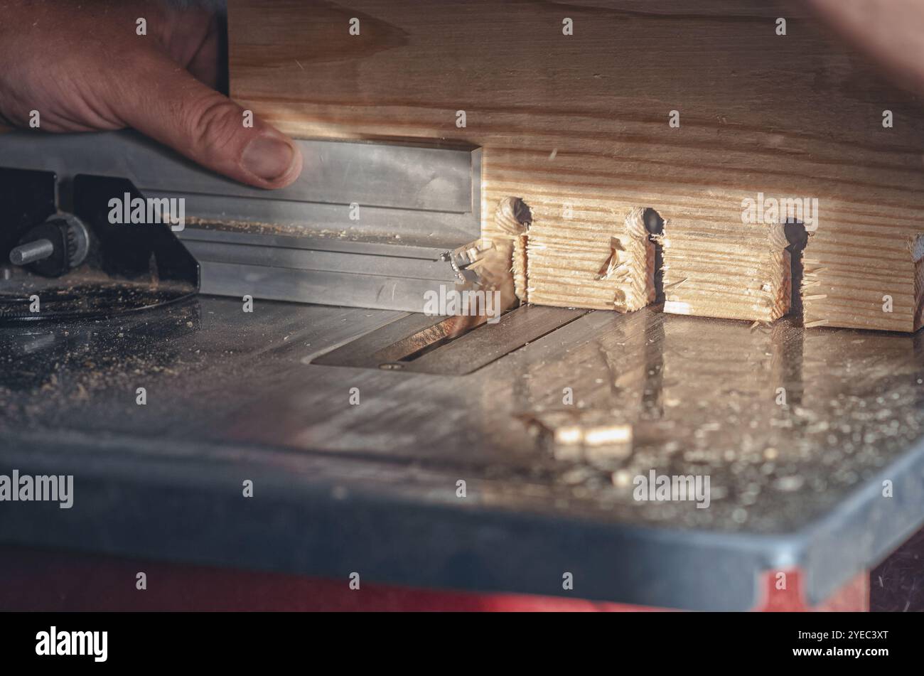 Large wooden board with round holes in carpentry workshop. Circular saw ...